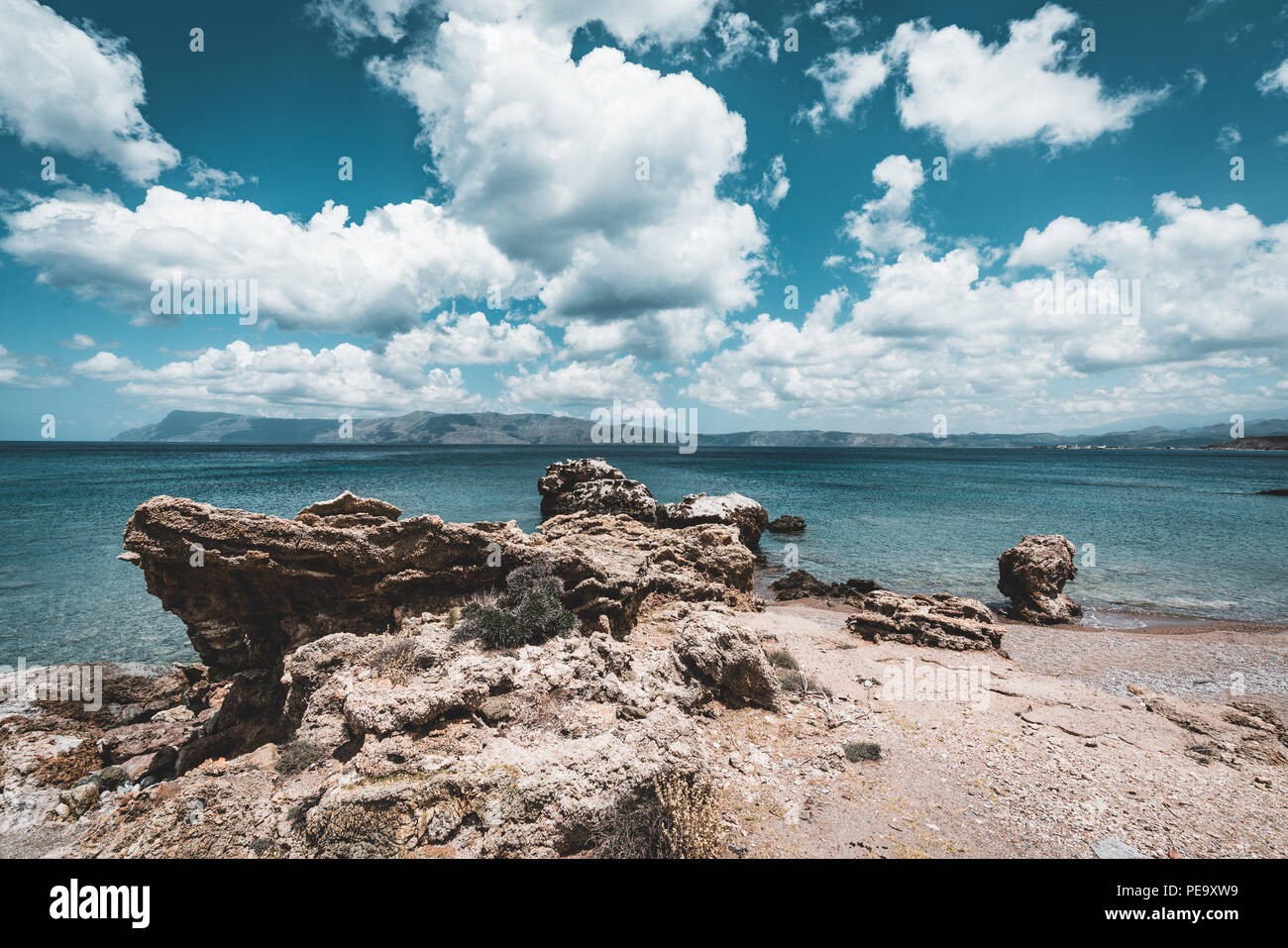 Panoramic view of rocks and beach with sky and clouds in Crete, Greece ...