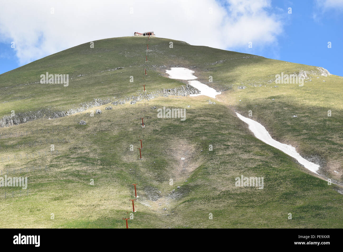 Mountain view with building on top and snow Stock Photo - Alamy