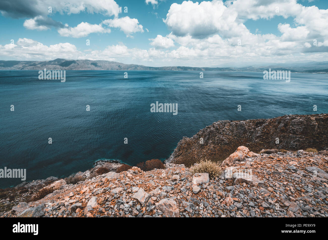 Panoramic view of rocks and beach with sky and clouds in Crete, Greece ...