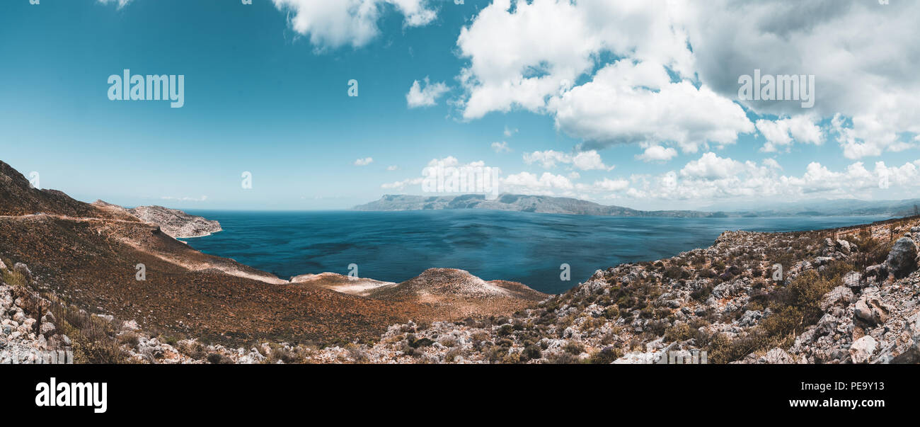Panoramic view of rocks and beach with sky and clouds in Crete, Greece ...