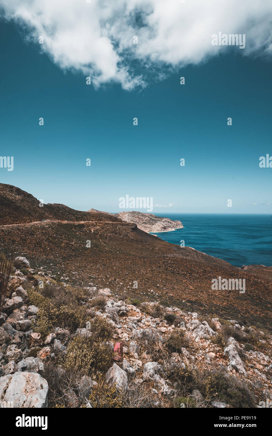 Panoramic view of rocks and beach with sky and clouds in Crete, Greece ...