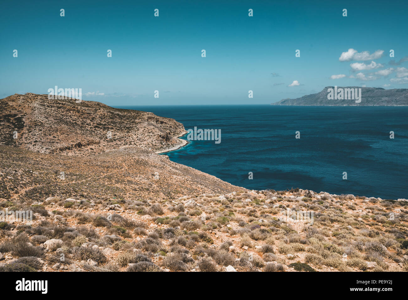 Panoramic view of rocks and beach with sky and clouds in Crete, Greece ...
