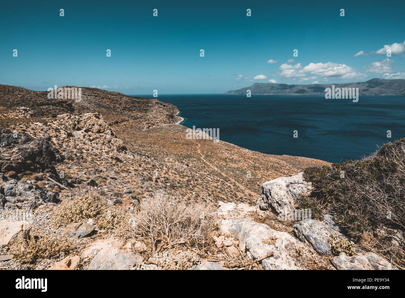 Panoramic view of rocks and beach with sky and clouds in Crete, Greece ...