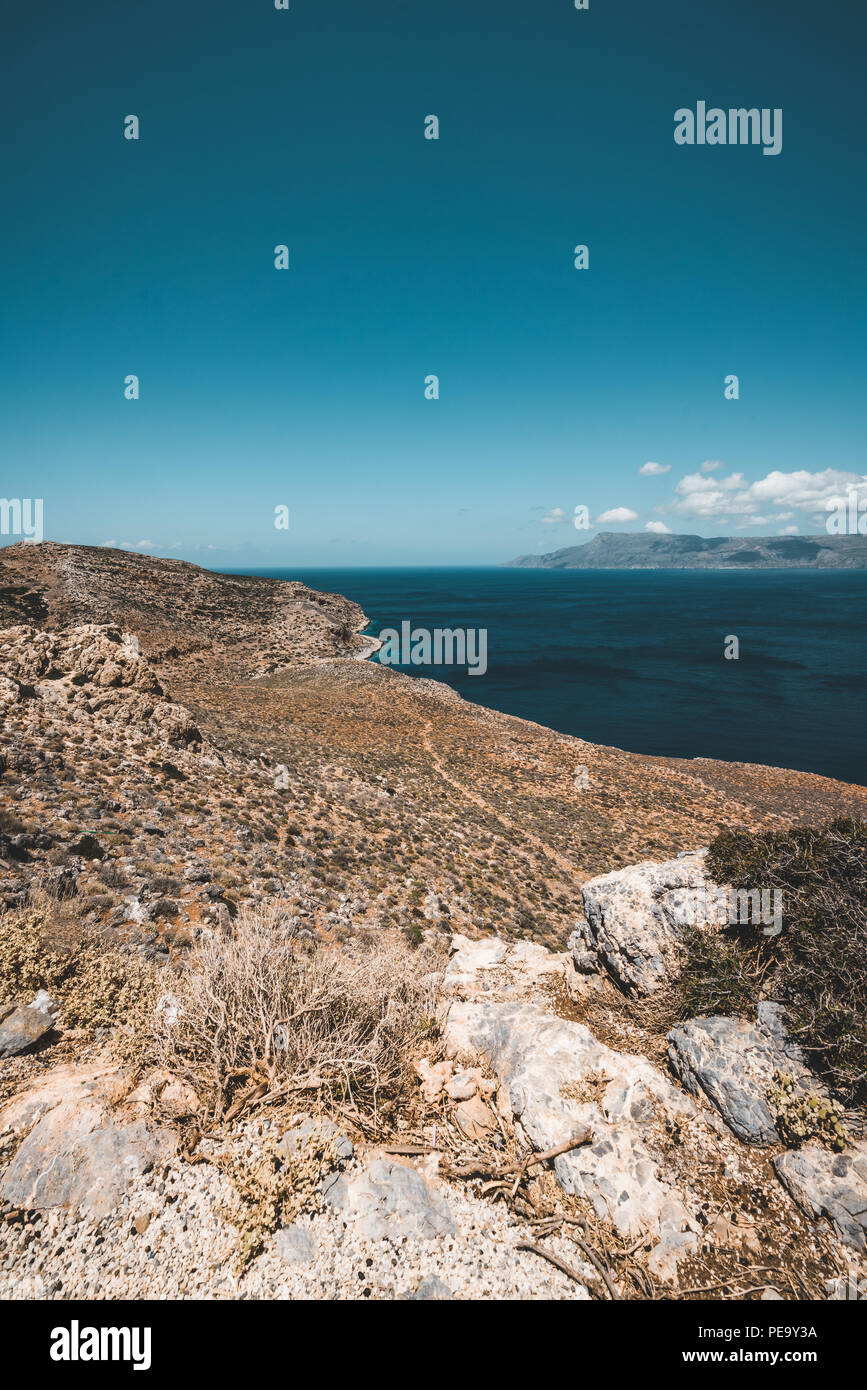 Panoramic view of rocks and beach with sky and clouds in Crete, Greece ...