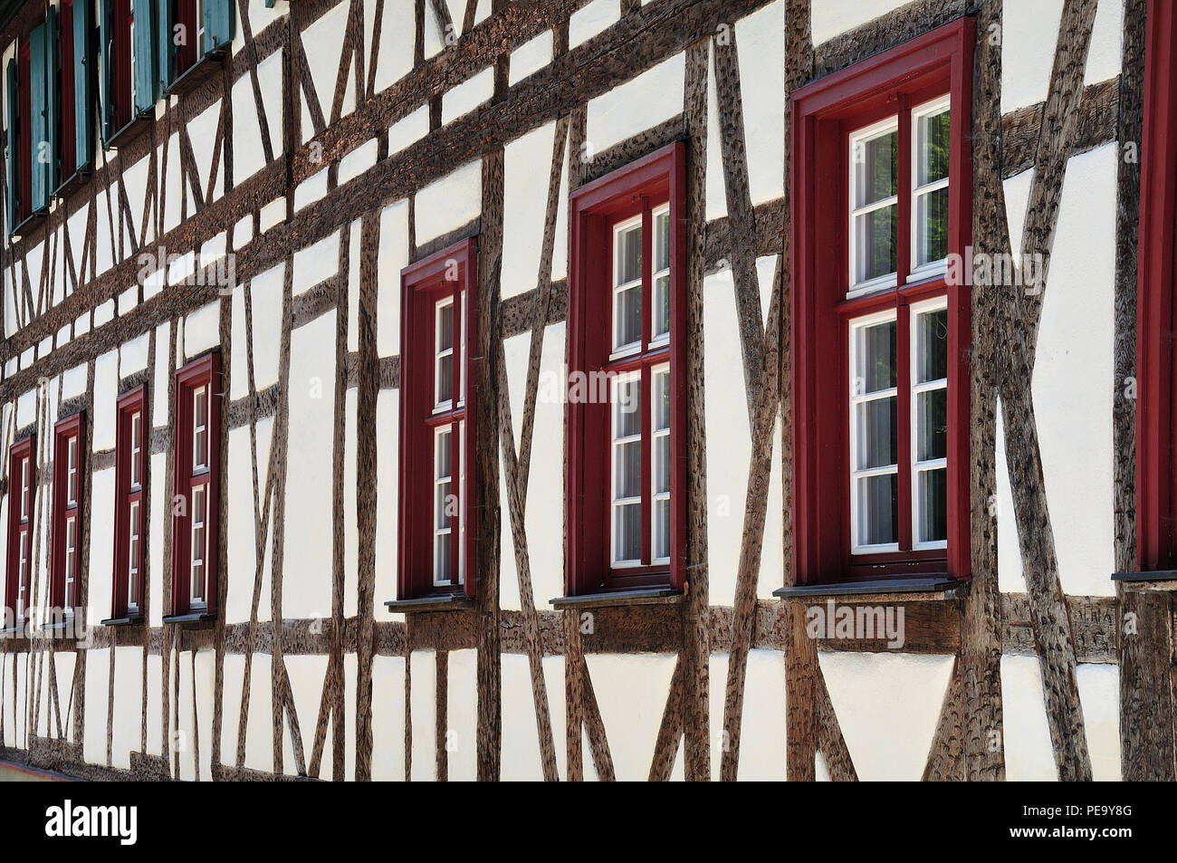 side view to a medieval building with half-timbered facade and red ...