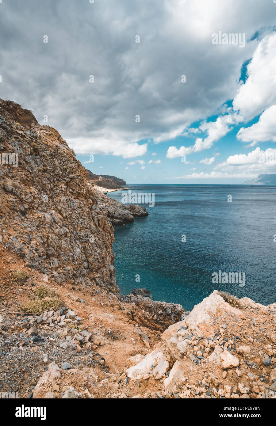 Panoramic view of rocks and beach with sky and clouds in Crete, Greece ...