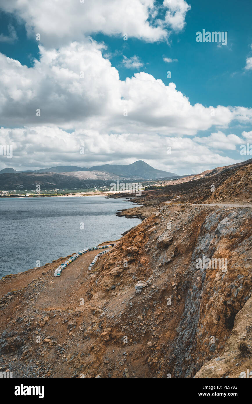 Panoramic view of rocks and beach with sky and clouds in Crete, Greece ...