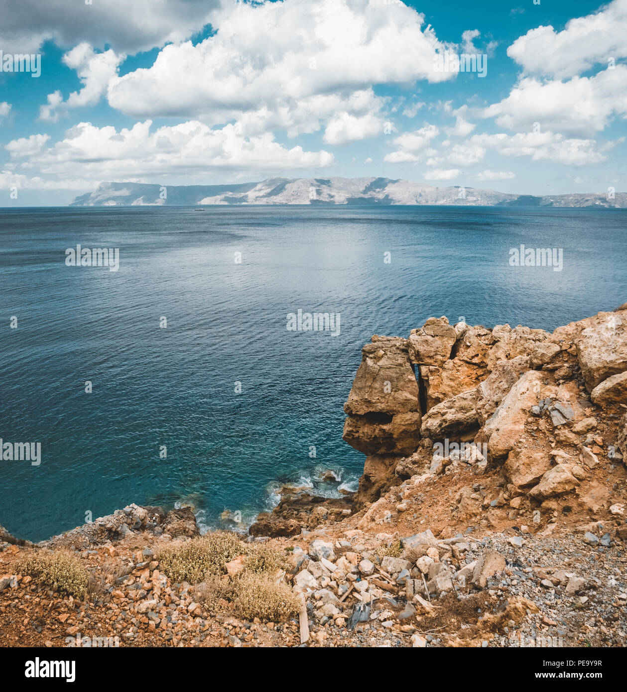 Panoramic view of rocks and beach with sky and clouds in Crete, Greece ...