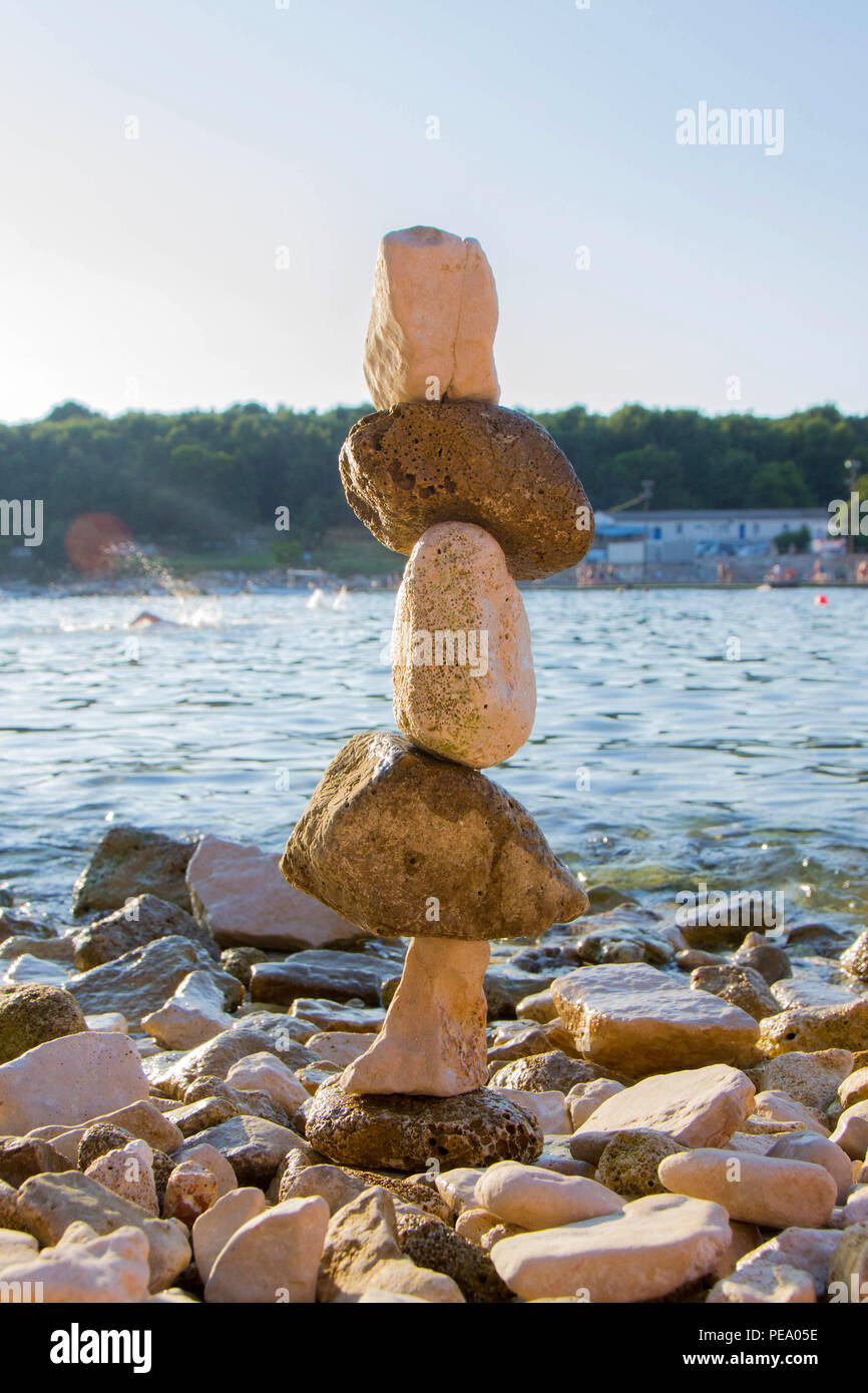 Pyramid of sea stones on pebbles of the sea shore. Seascape. The ...