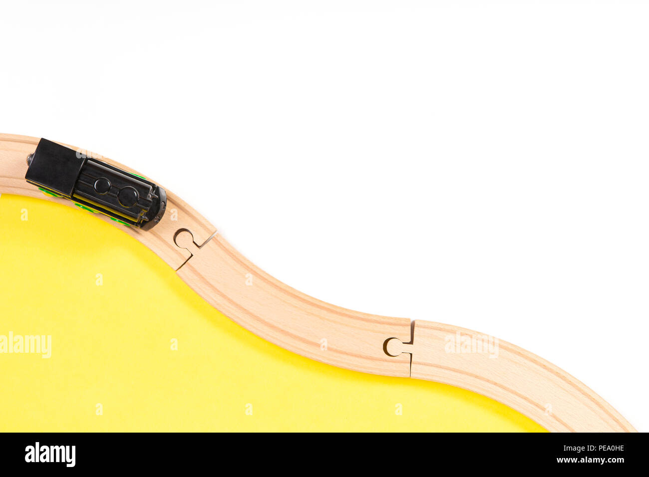 Toy train and curve wooden railways on colorful background Stock Photo ...