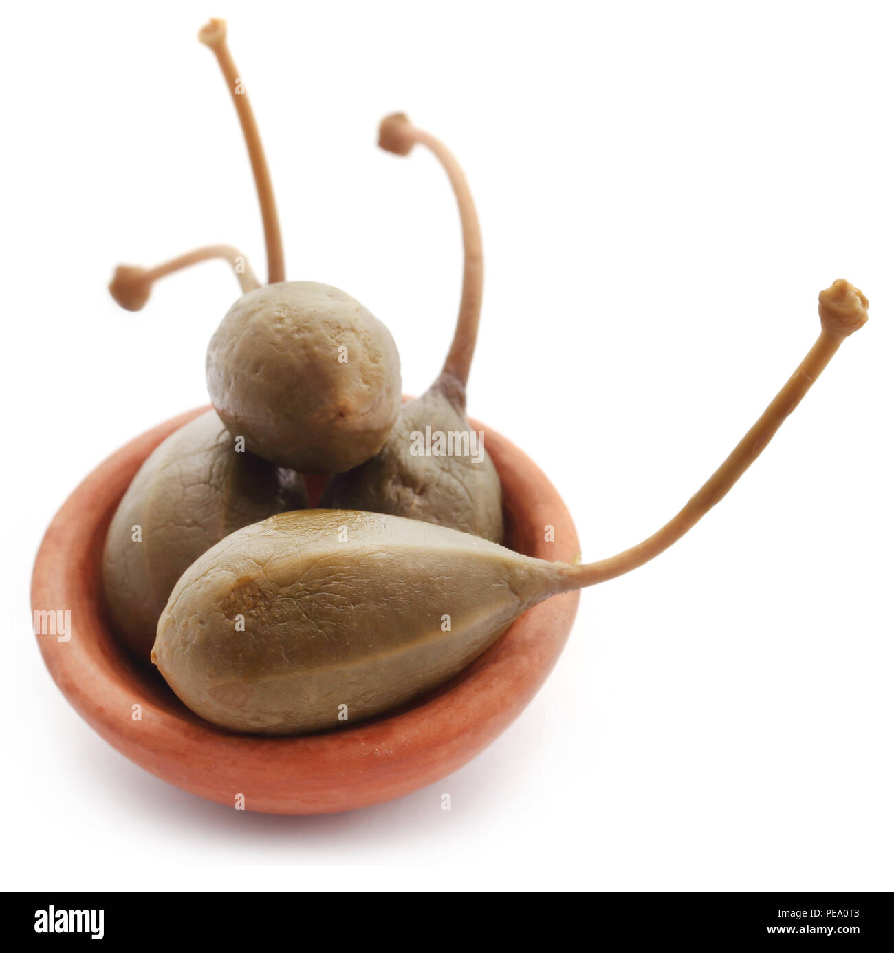 Caper berry in a bowl over white background Stock Photo - Alamy