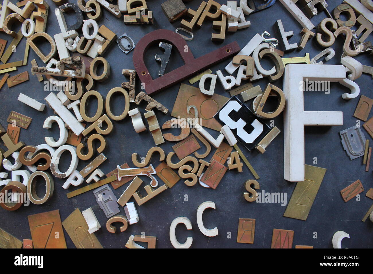 Collection of metal text printing blocks scattered on a table top at ...