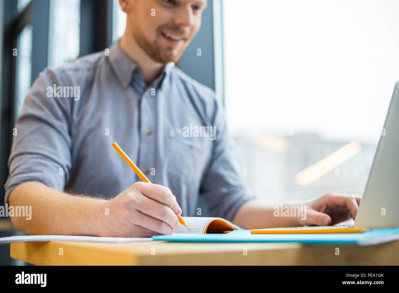 Taking notes. Selective focus of a pencil being used by a positive nice ...