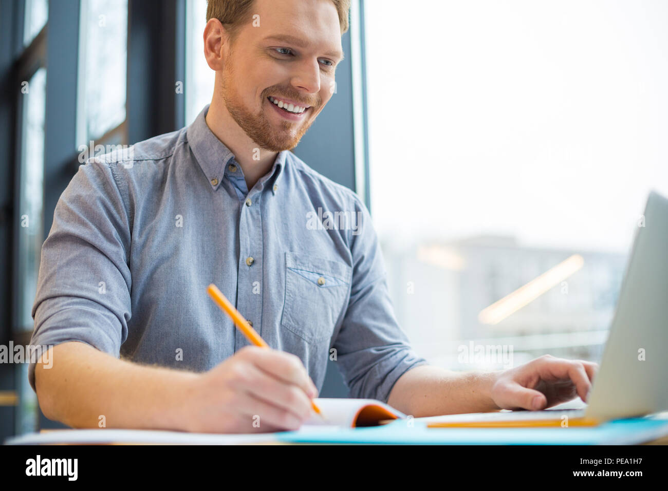 Man sitting at table alone writing hi-res stock photography and images ...