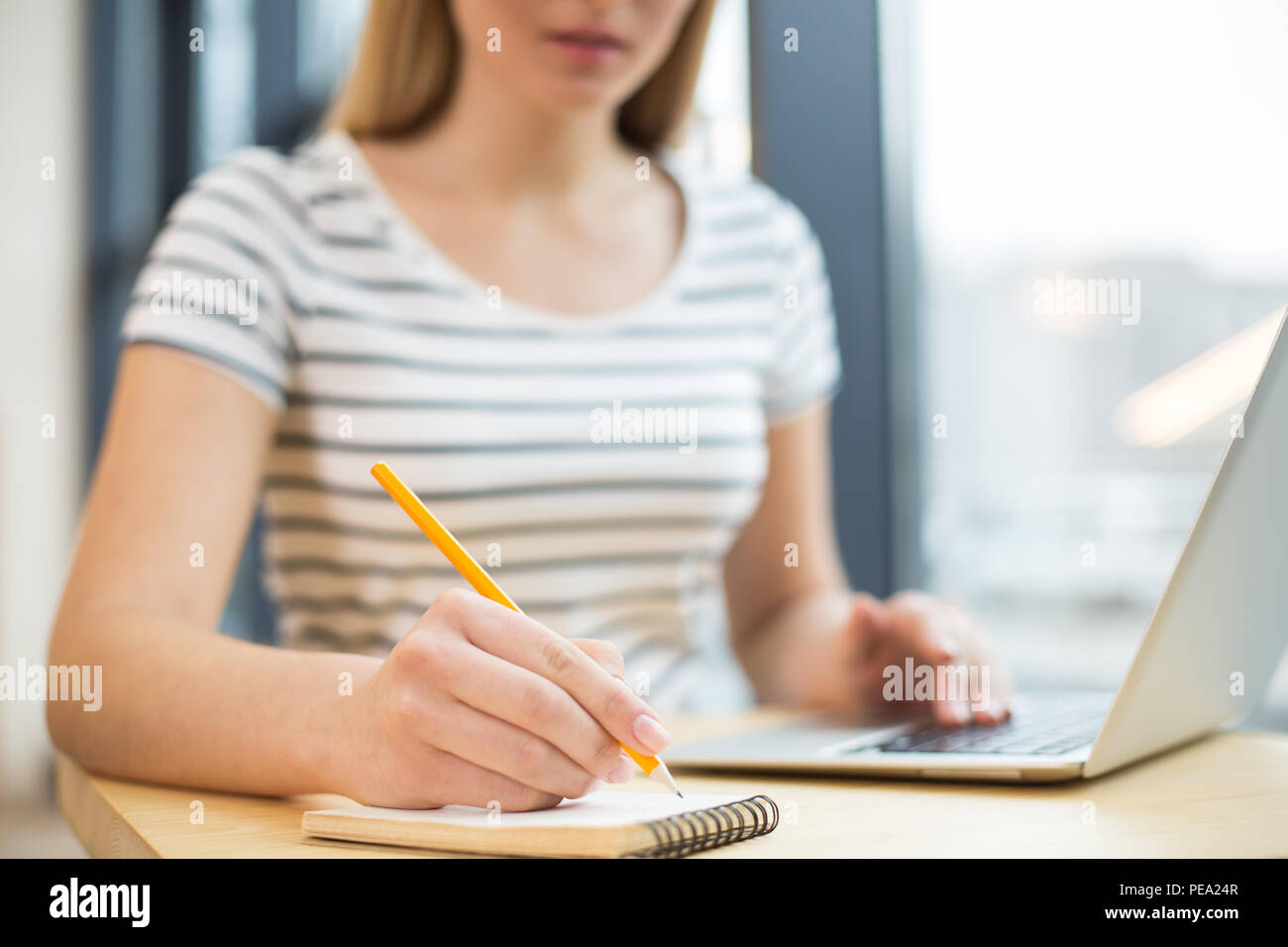 Everyday notes. Selective focus of a small notebook being used by a ...