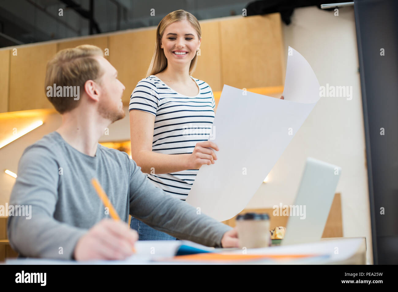 Working together. Happy nice positive people looking at each other and ...