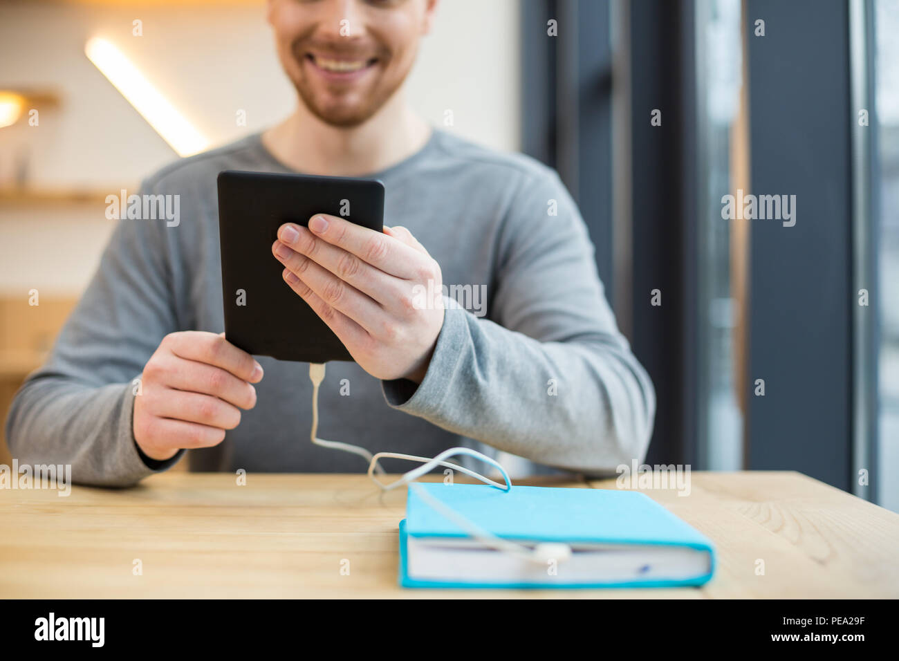 Modern device. Selective focus of an e reader being in hands of a smart ...