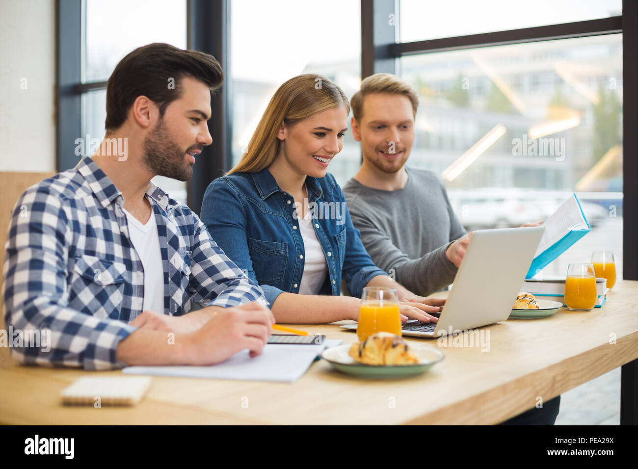Professional team. Positive nice smart colleagues sitting together in ...
