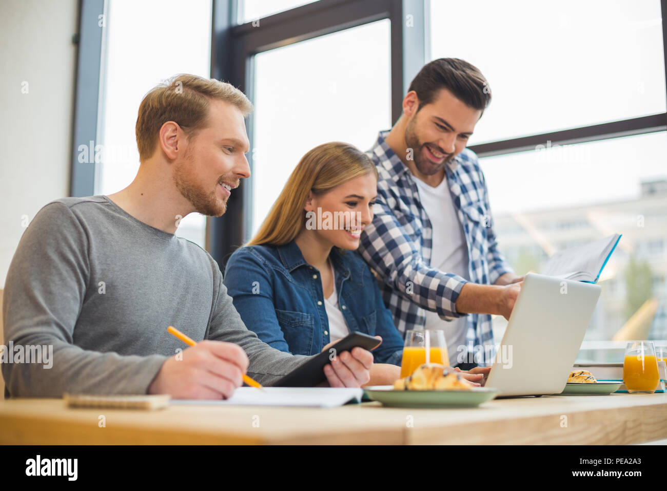 Professional cooperation. Nice positive smart people sitting together ...