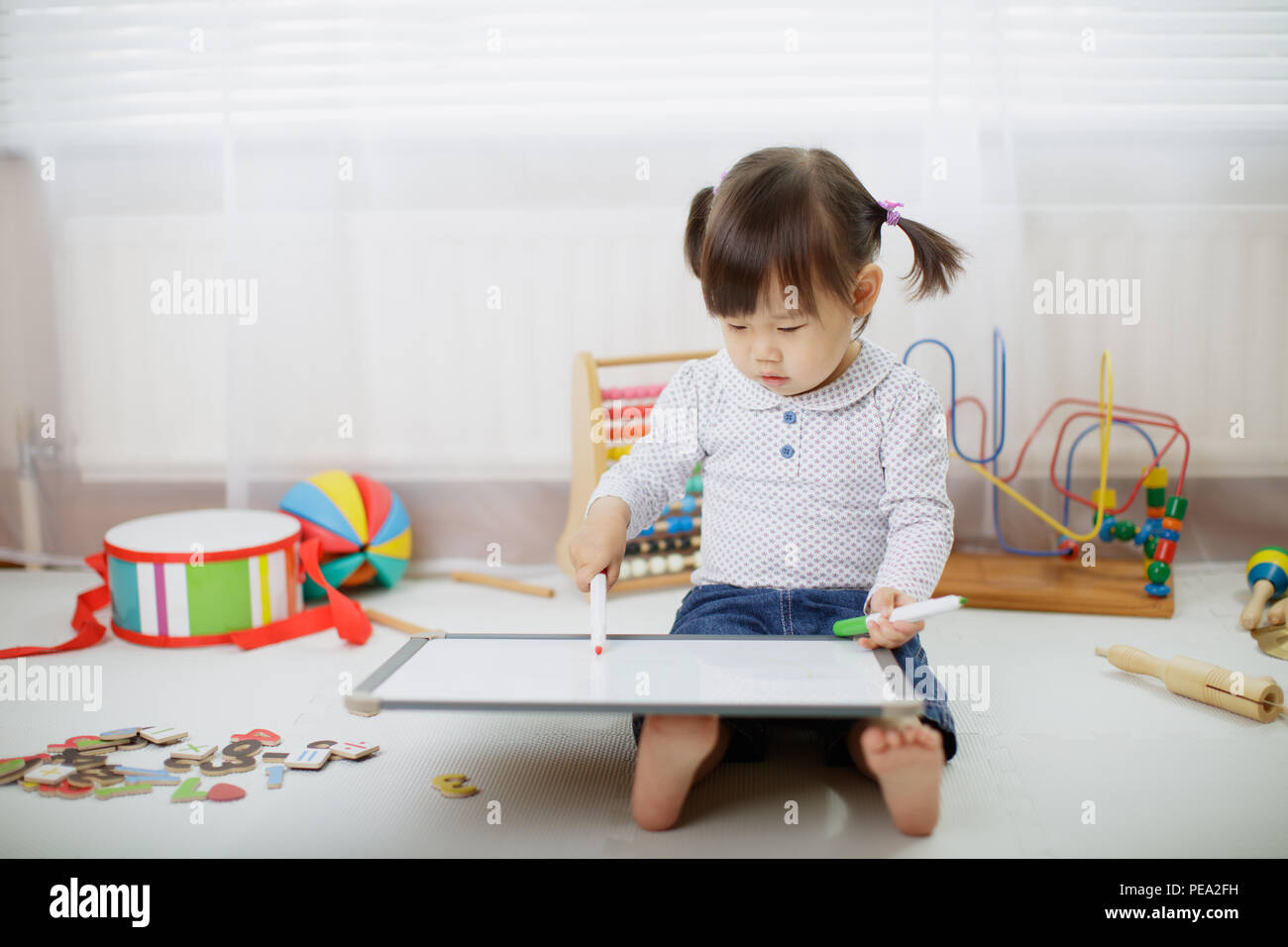 baby girl learning draw at home Stock Photo - Alamy