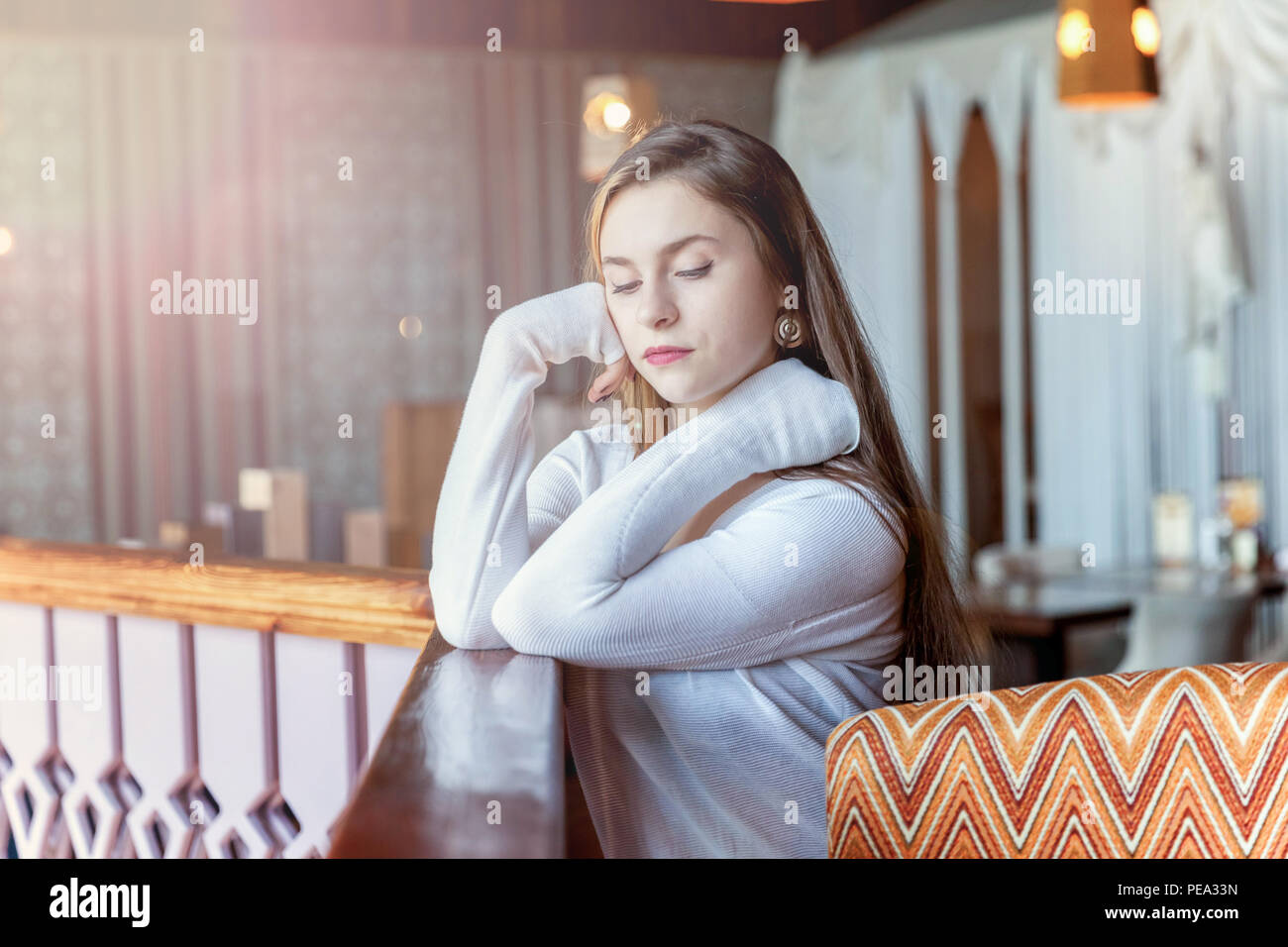 Beautiful teenage young smiling brunette girl sitting in cafe or bar at ...