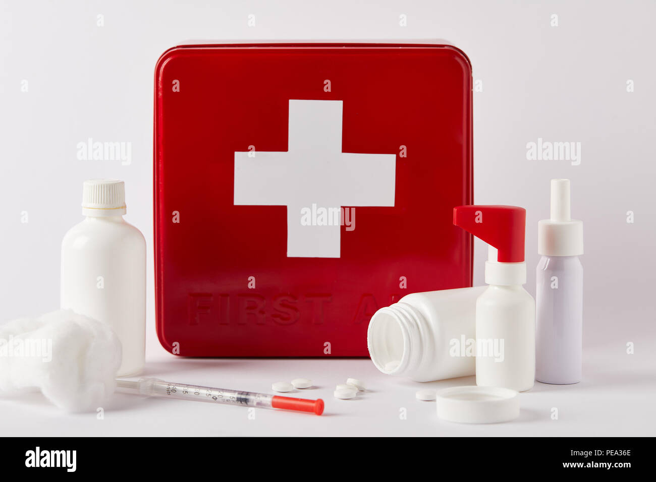 first aid kit box with blank medical bottles, syringe and cotton swab ...