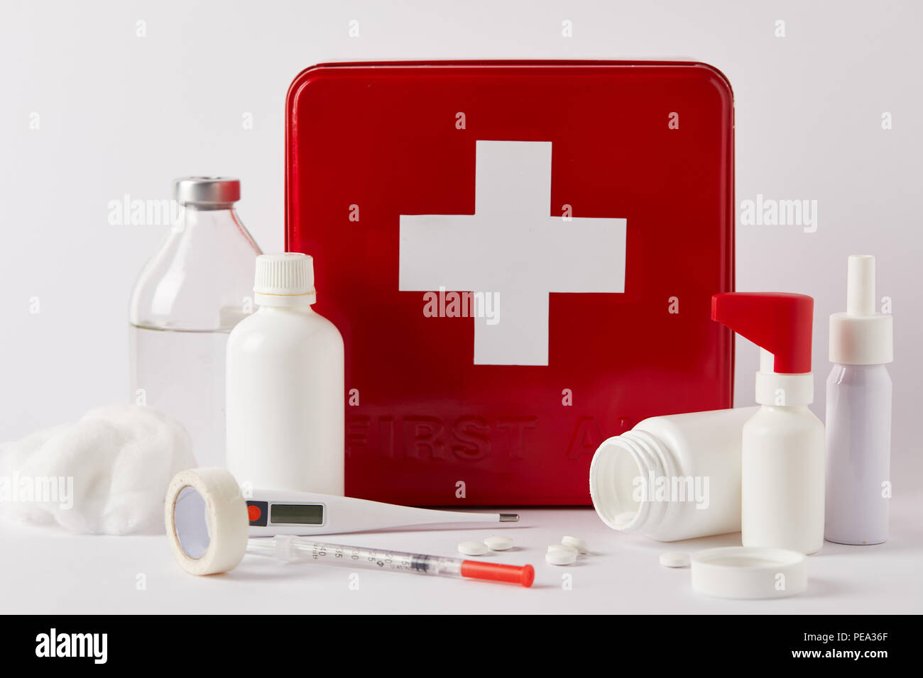 close-up shot of red first aid kit box with various medical bottles and ...