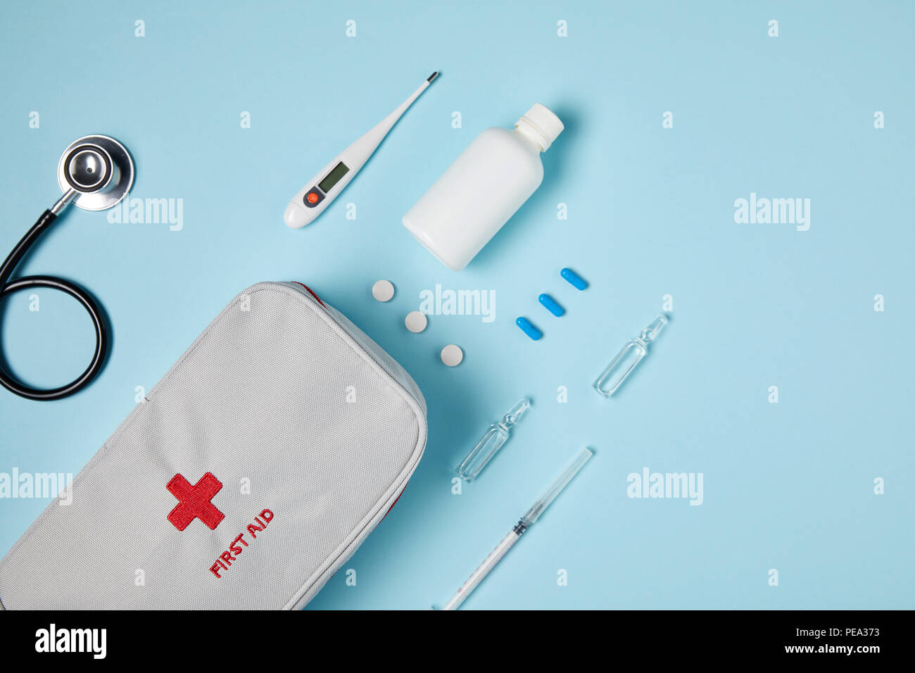 top view of white first aid kit bag with stethoscope and various ...