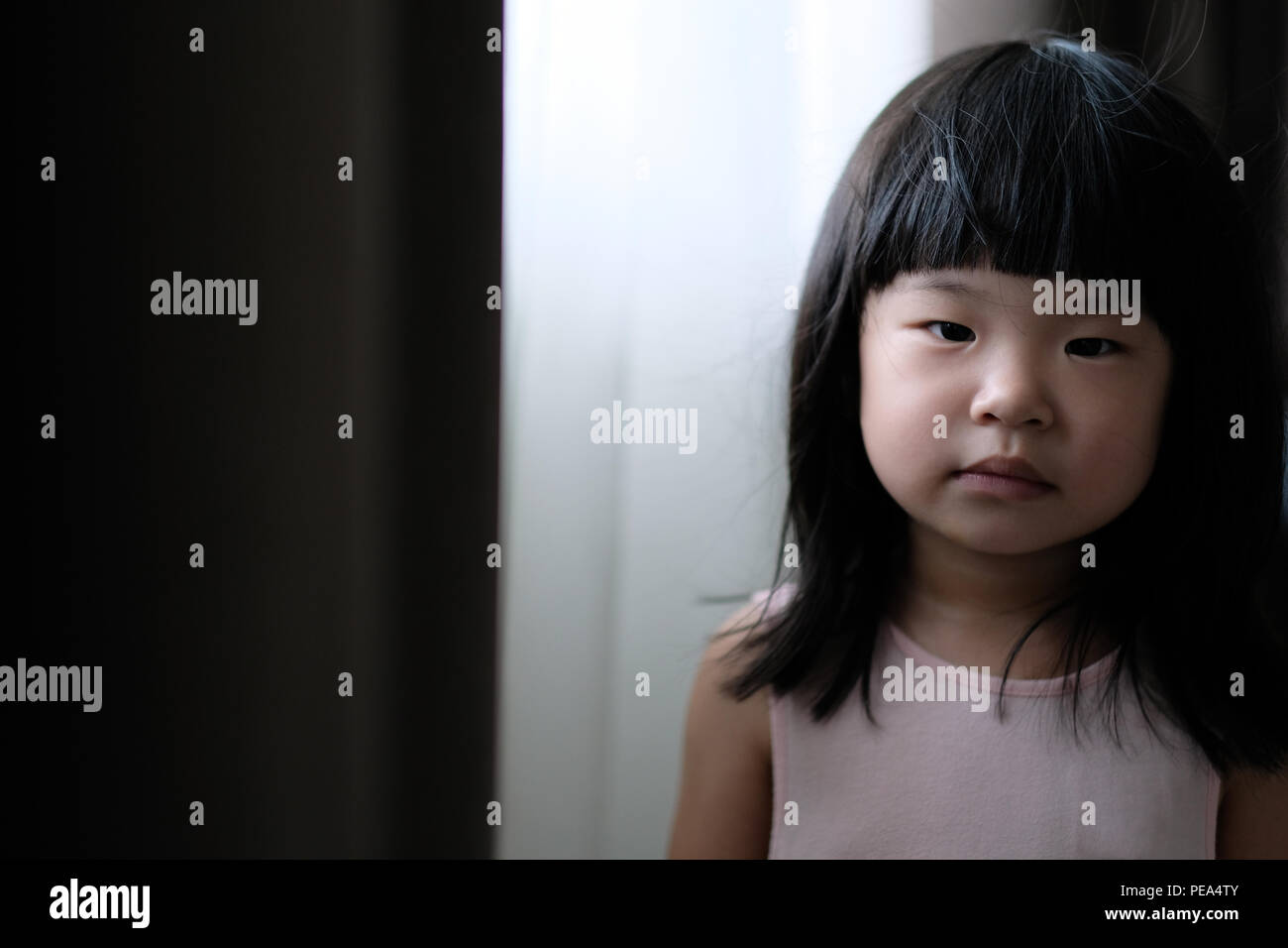 Sad lonely little girl looking at camera Stock Photo - Alamy