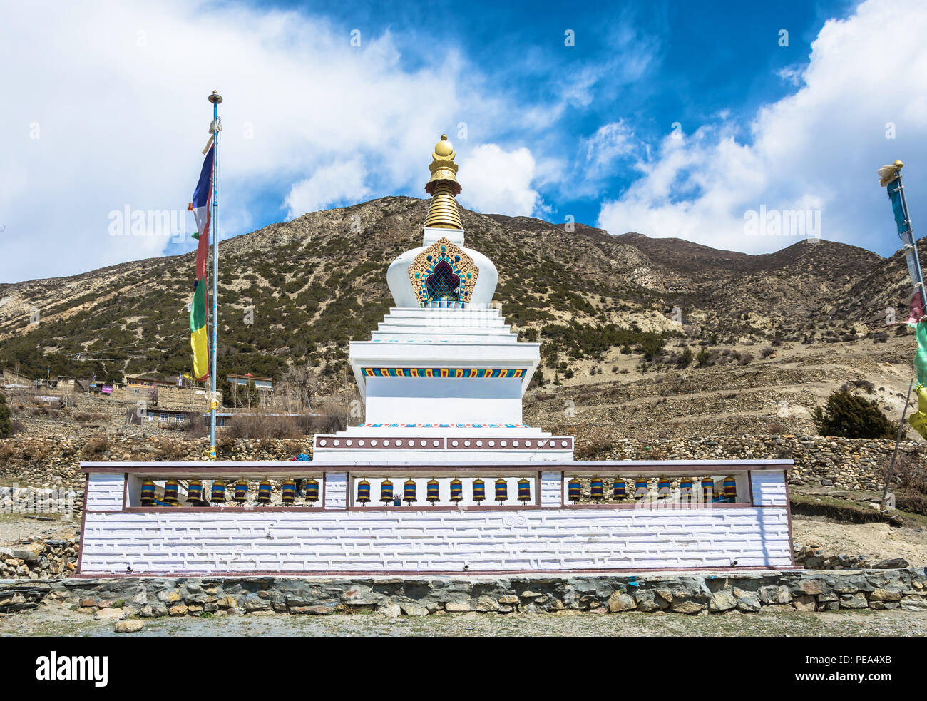 Large white stone Buddhist stupa in a mountain village in the Himalayas ...