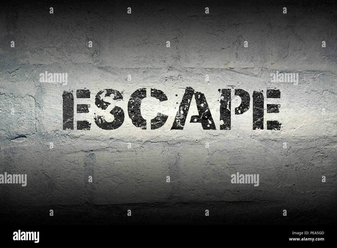 escape stencil print on the grunge white brick wall Stock Photo - Alamy
