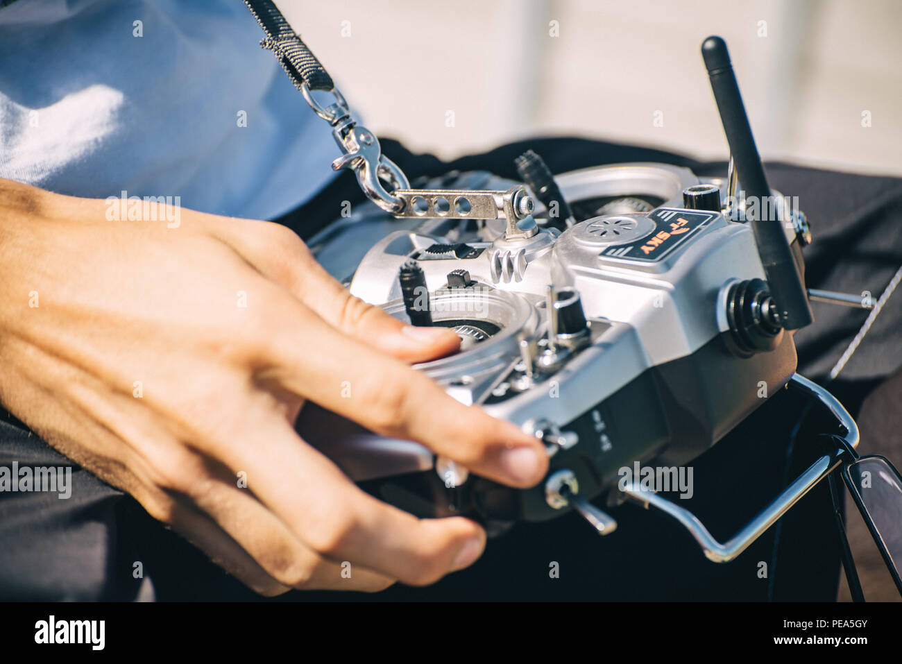 Hands holding joystick control panel on background Stock Photo - Alamy