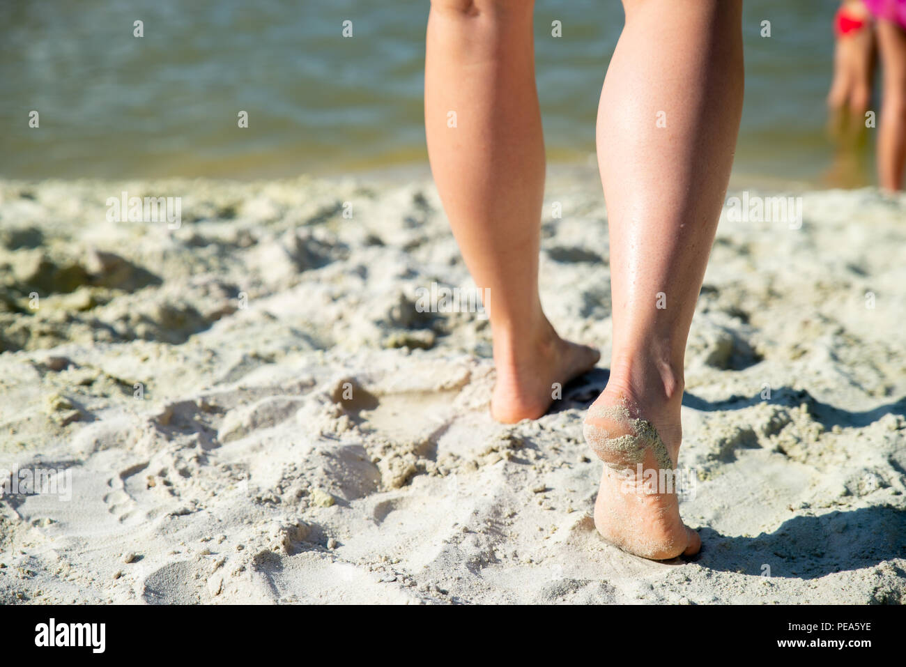 woman legs close up. walking by sand beach. vacation concept Stock ...