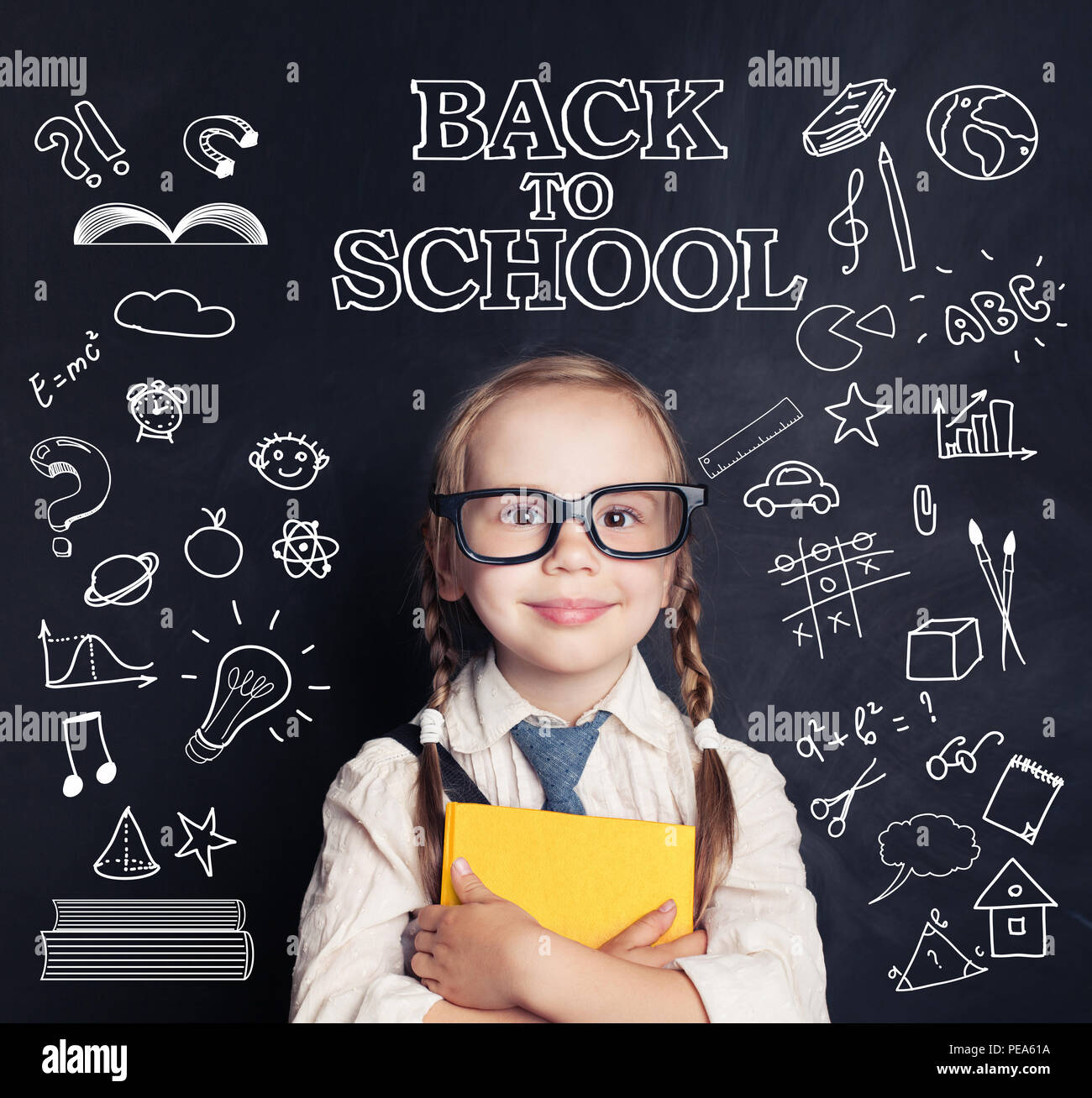 Cute child schoolgirl in classroom on blackboard background and pattern ...