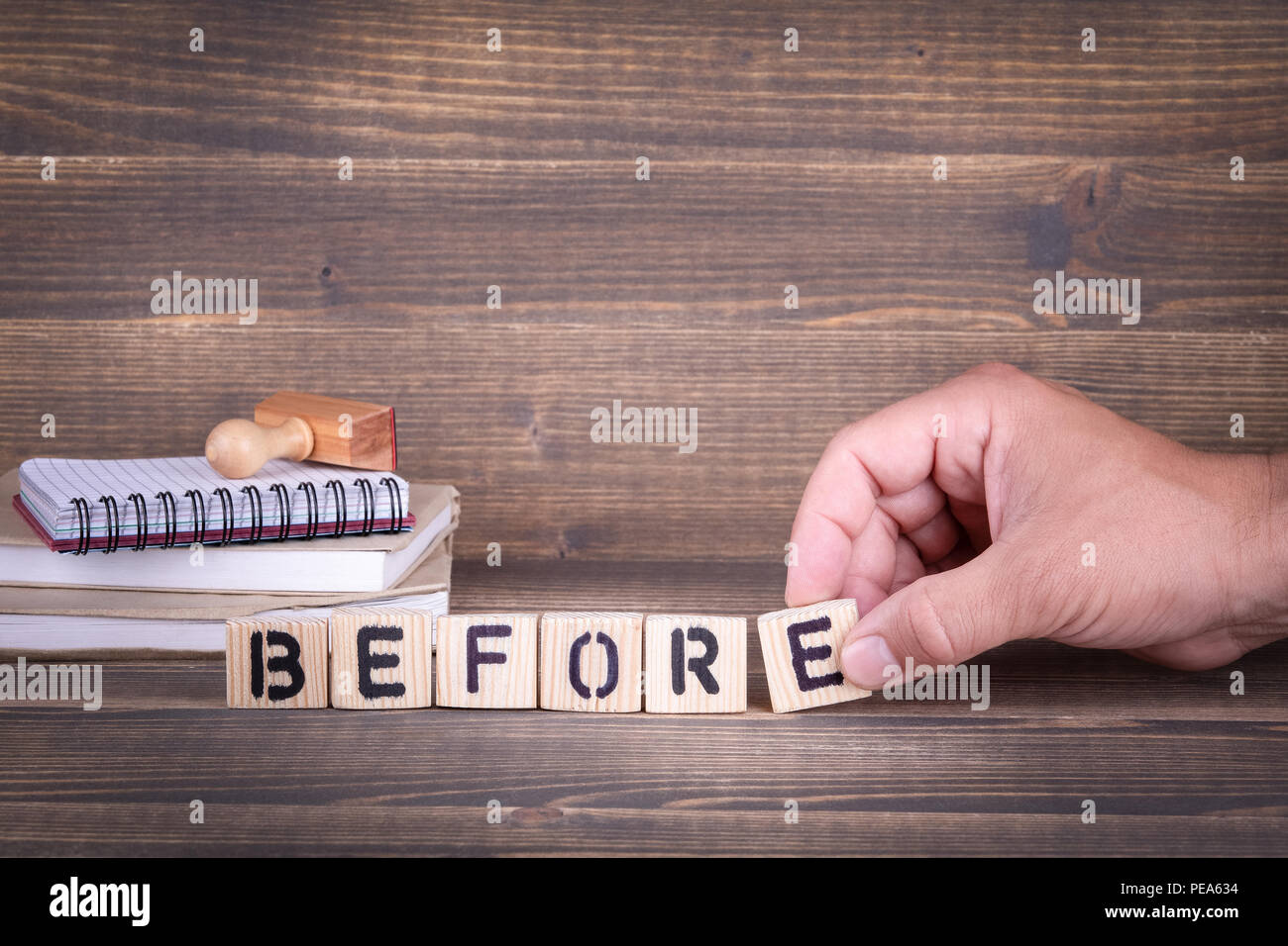 before. Wooden letters on the office desk Stock Photo - Alamy