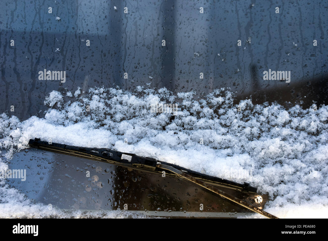 Car wiper cleans glass of snow and rain in the winter Stock Photo - Alamy