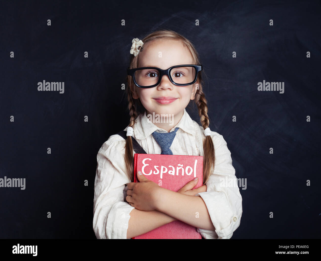 Happy child girl student against spanish language school chalkboard ...