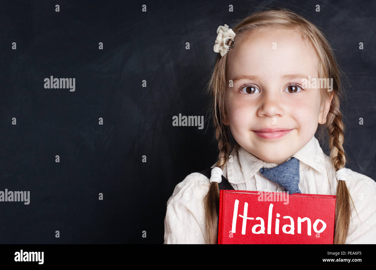 Schoolgirl student learning italian with Italiano book Stock Photo - Alamy