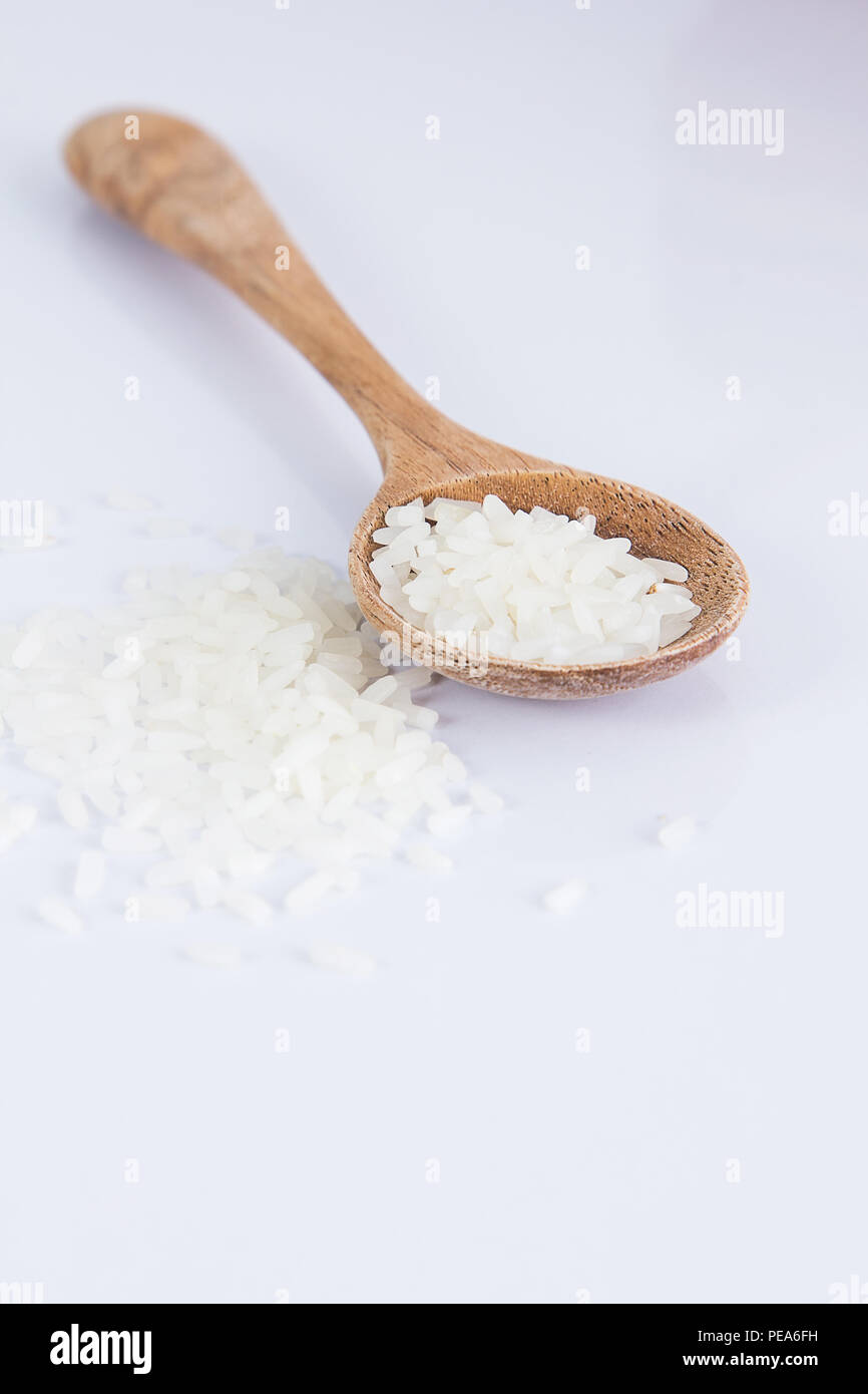 Raw and uncooked rice in wooden spoon,shallow Depth of Field,Focus on ...