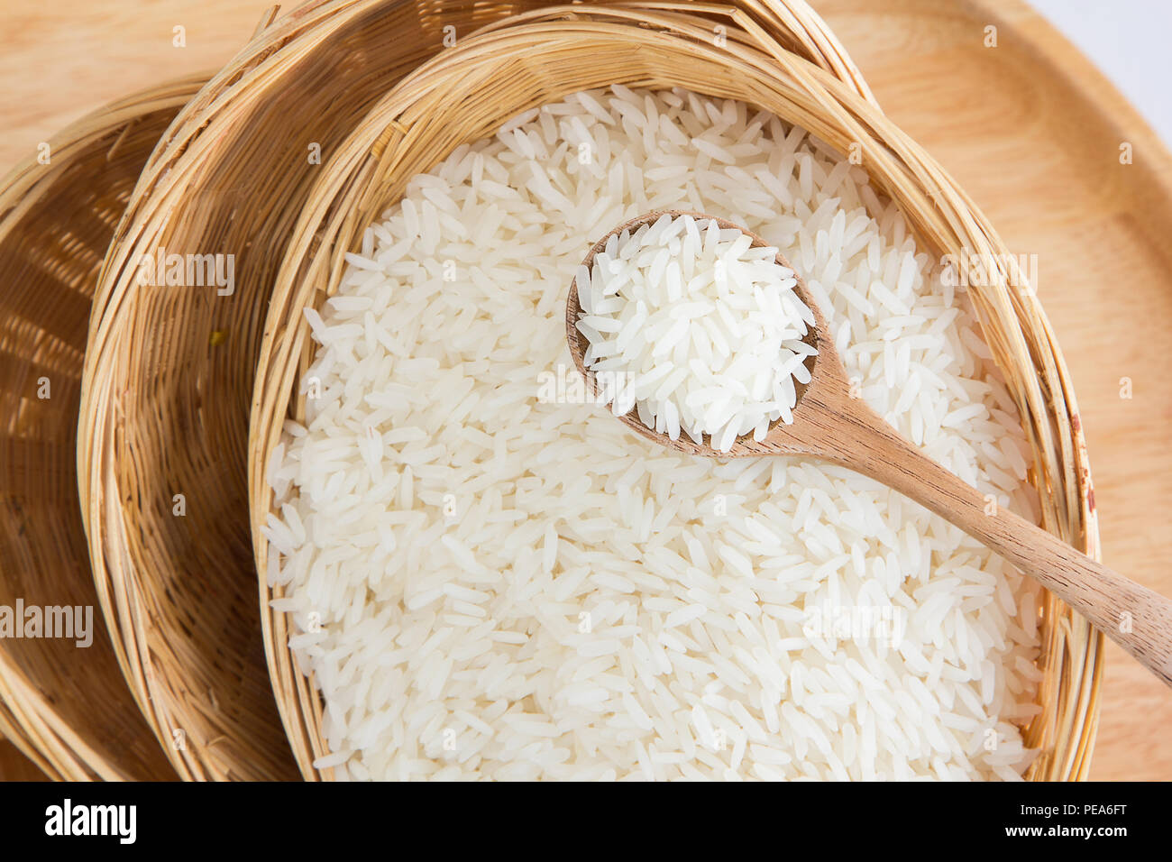 Raw and uncooked rice in wooden spoon,shallow Depth of Field,Focus on ...