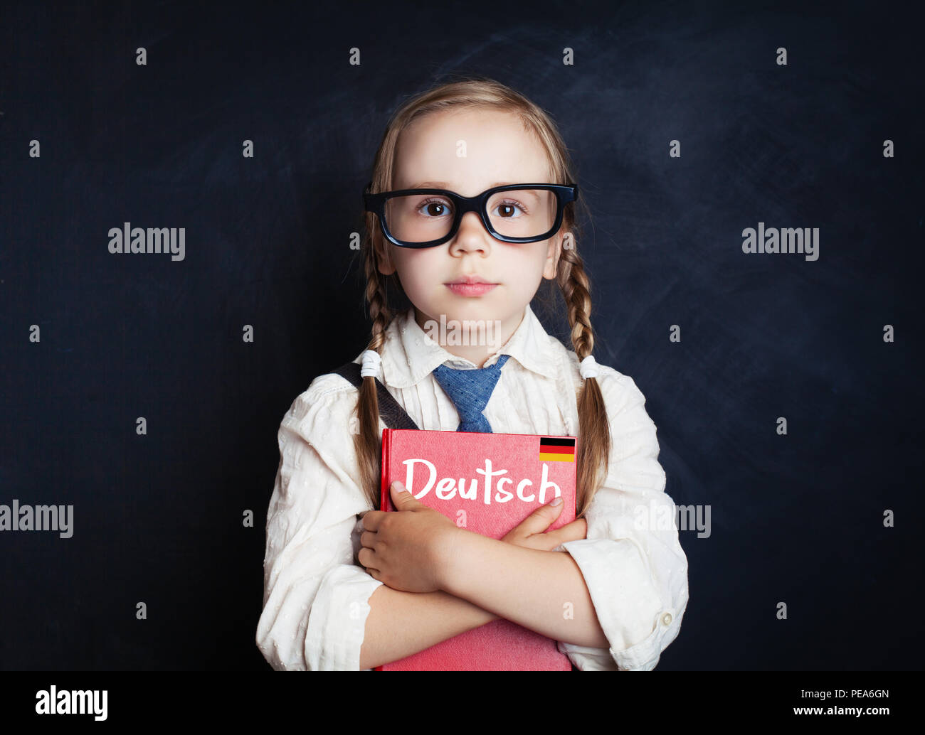 German language concept. Cute kid schoolgirl in classroom against ...