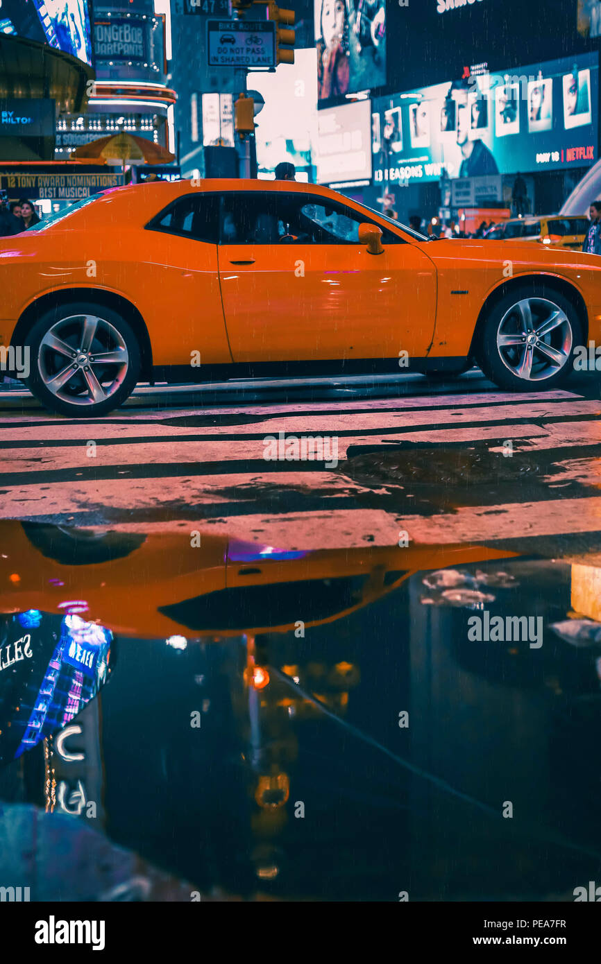 American muscle car passing through time square during the day Stock ...