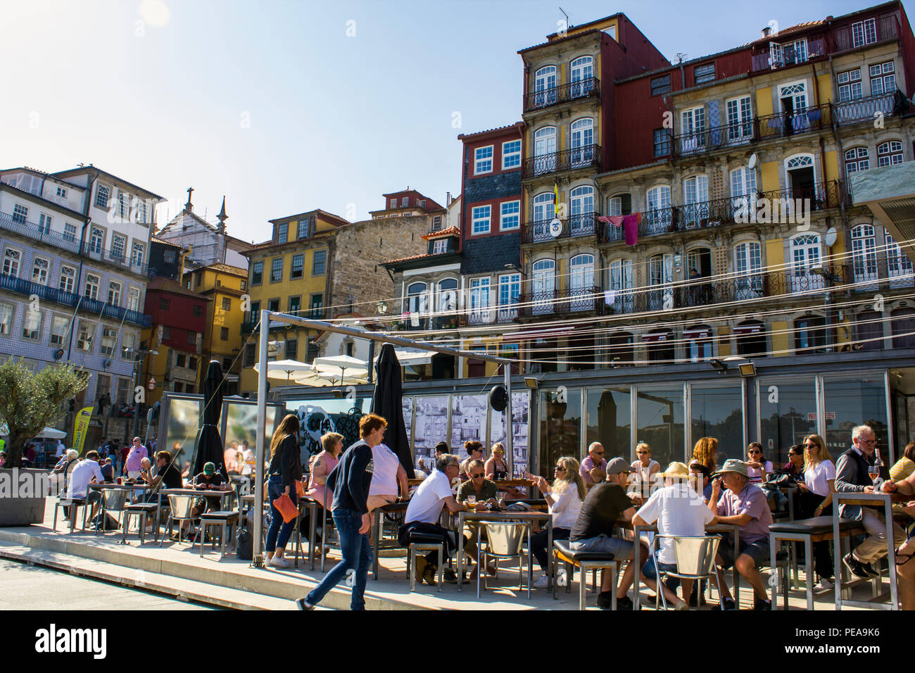 Typical houses and outdoor cafes at historic Ribeira Square of Porto ...