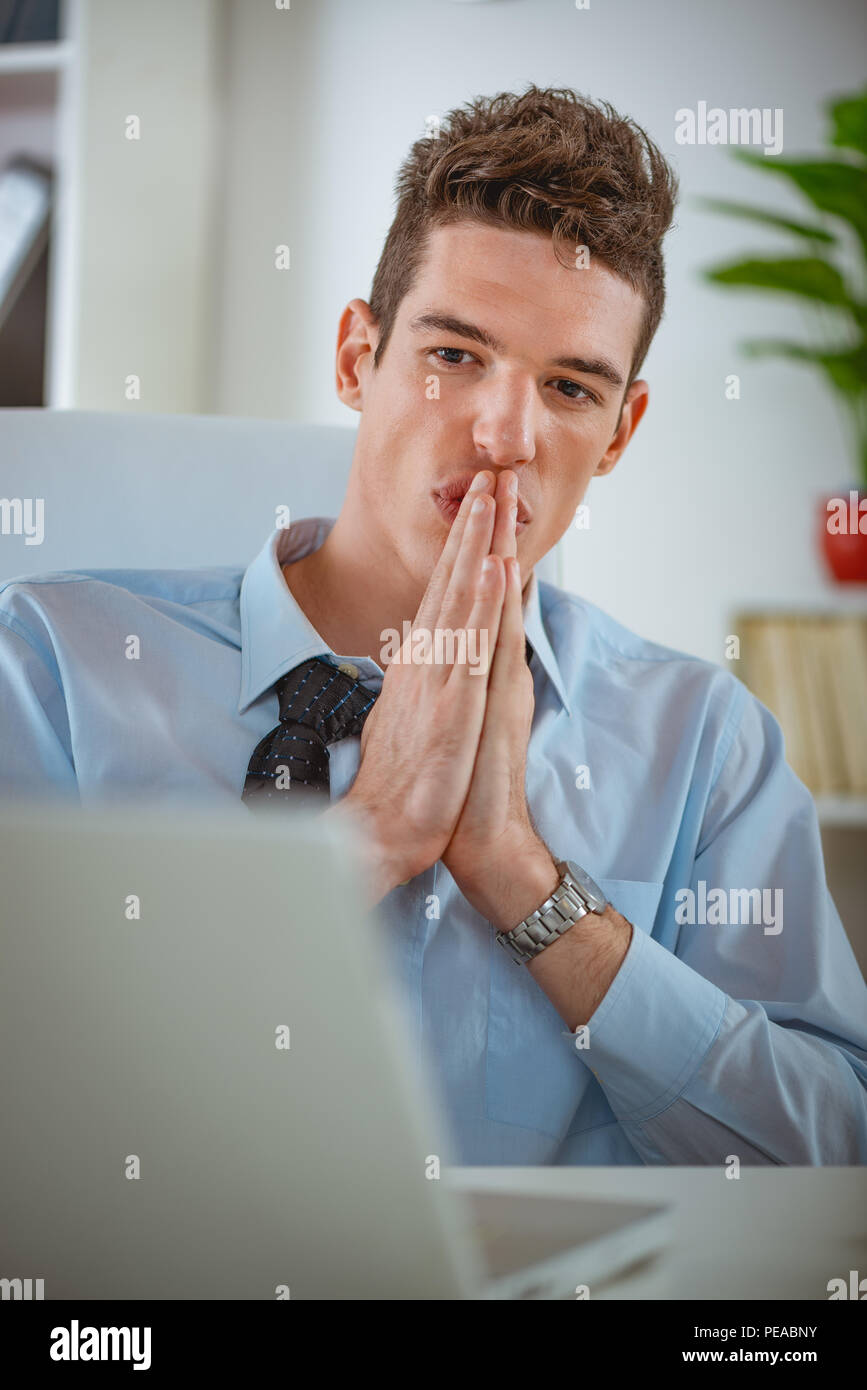 Executive male working at laptop looking at documents and accounts. He ...