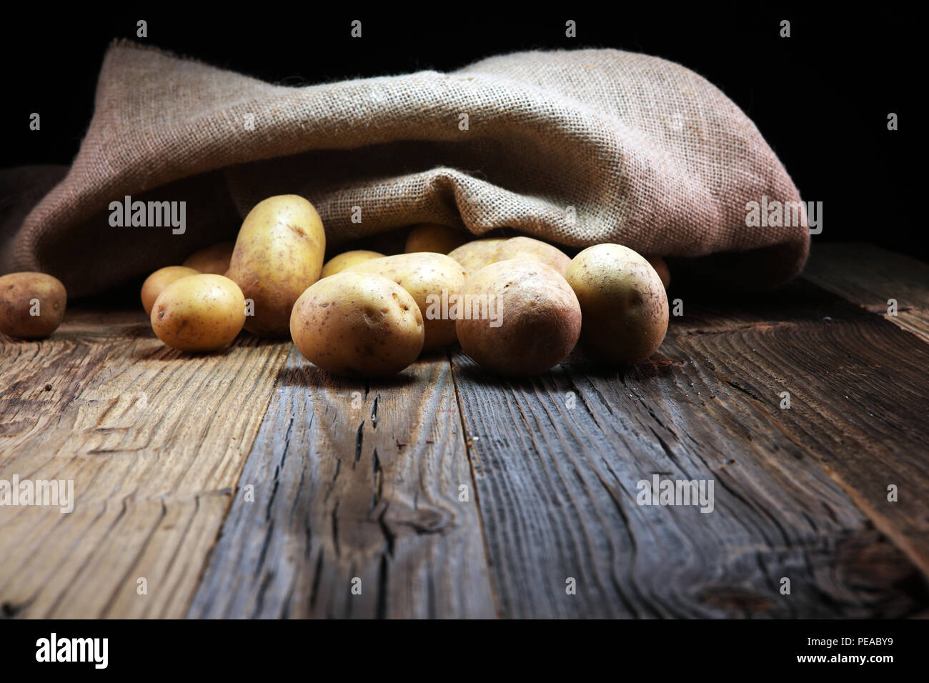 potato food . Fresh raw organic potatoes on old vintage background ...