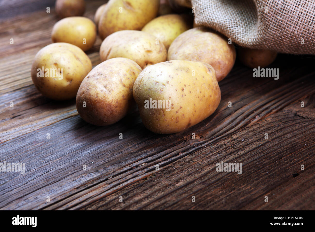 potato food . Fresh raw organic potatoes on old vintage background ...