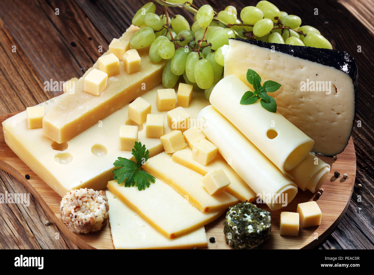 Cheese platter with different cheese and grapes Stock Photo - Alamy