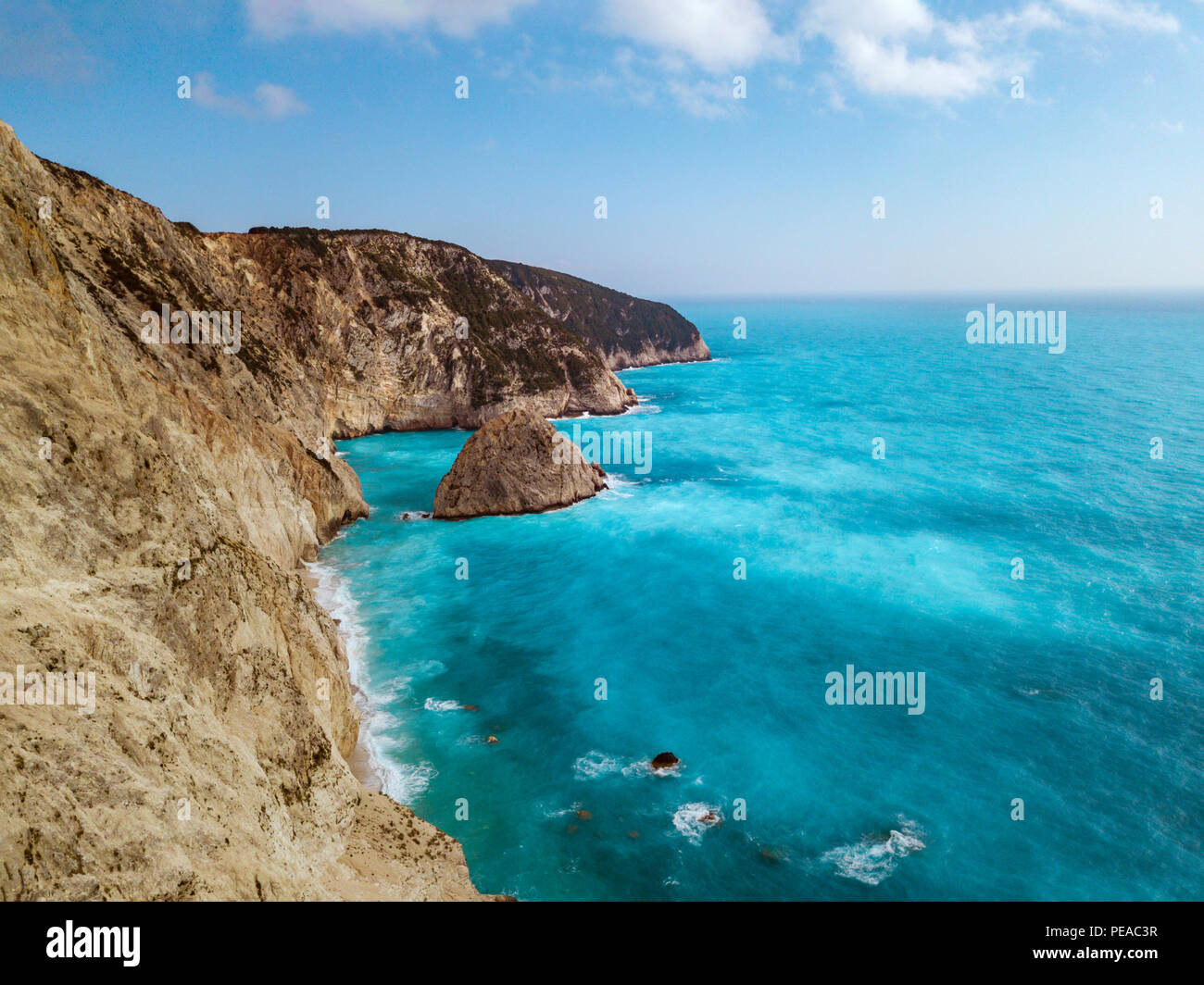 Aerial views of the turquoise sea water with wild seashore and waves ...