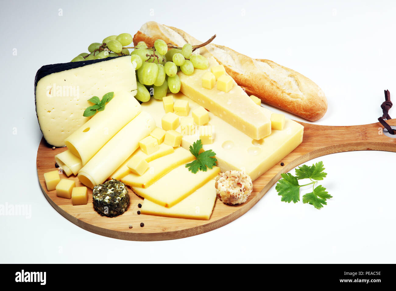 Cheese platter with different cheese and grapes Stock Photo - Alamy