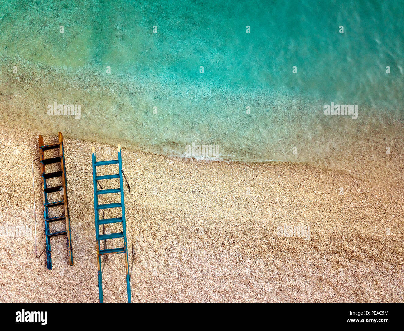 Top view of a beautiful tropical empty beach with two ladders for ...